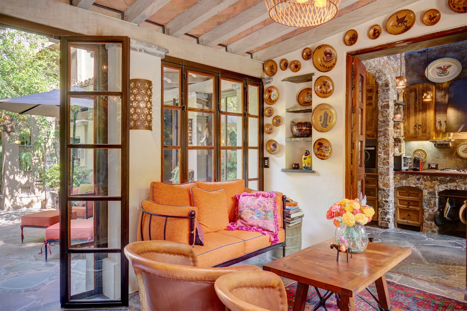 Enclosed seating area by Kitchen and straddles two outdoor seating areas