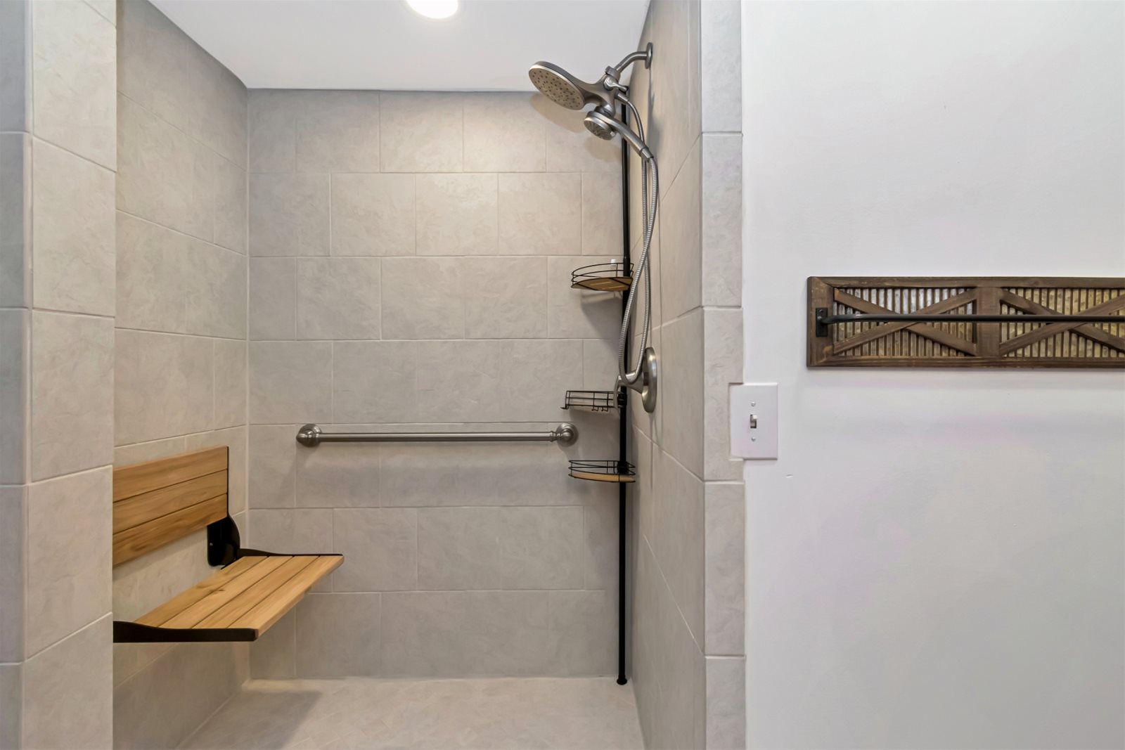 Walk in shower with fold down bench, grab bars.