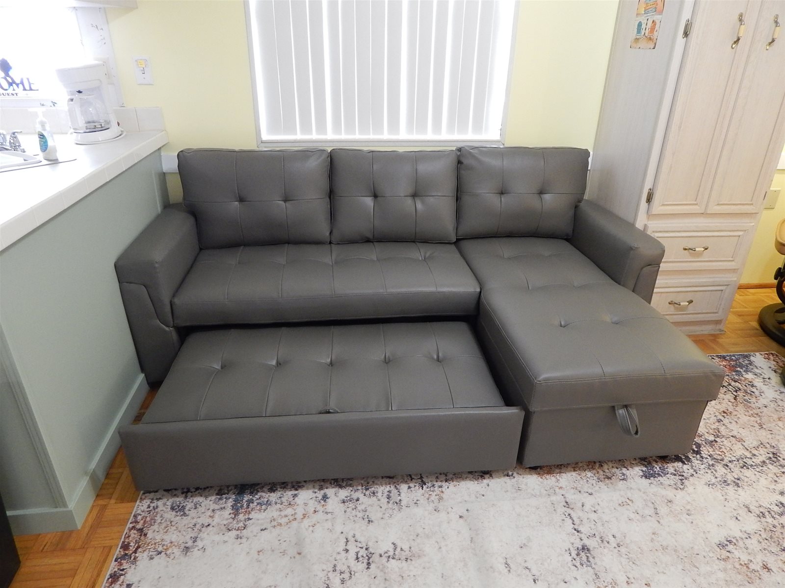 Pull out the bottom of the couch like it`s a drawer